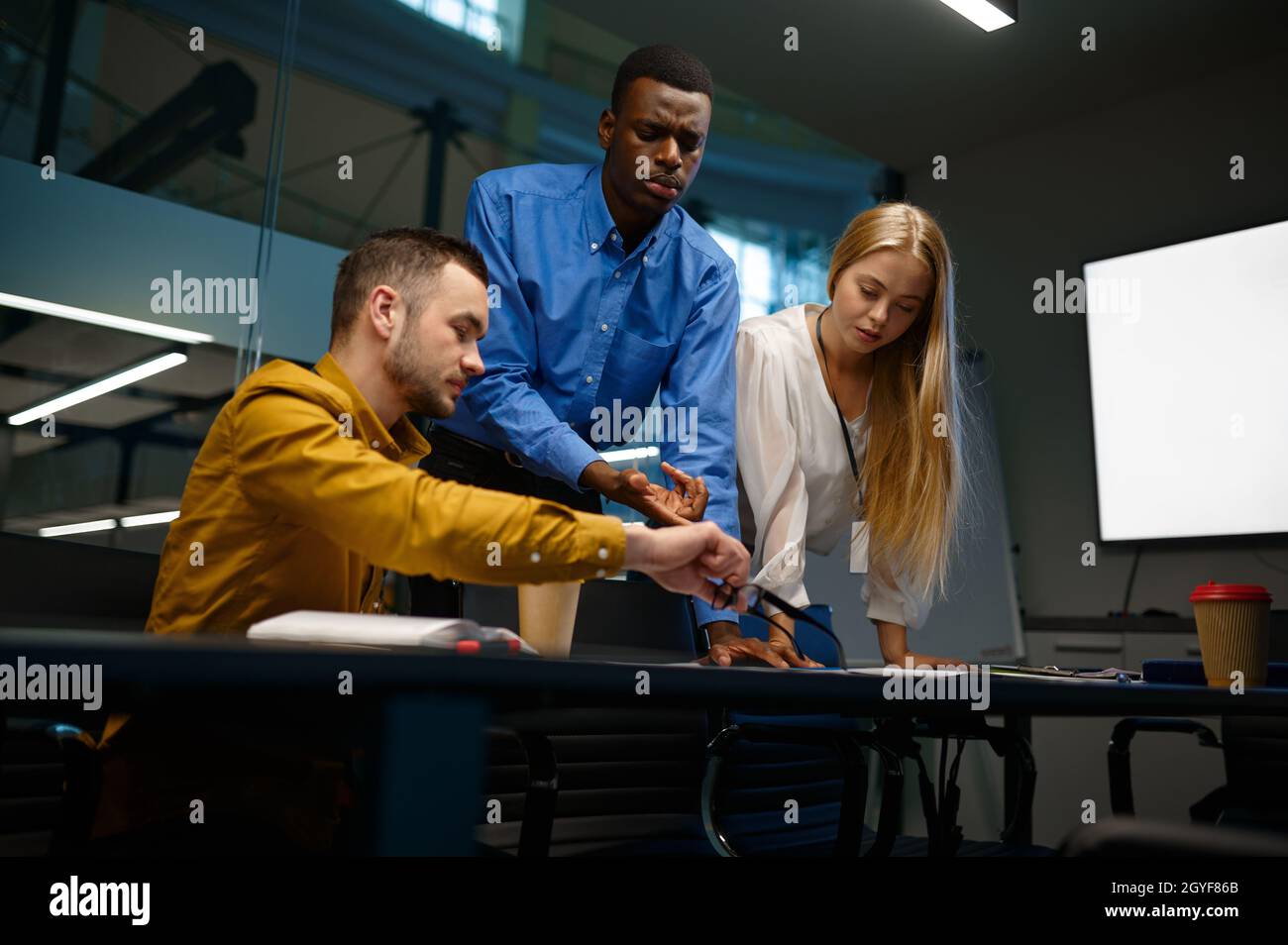 Team of young managers, discussion in IT business office. Professional ...