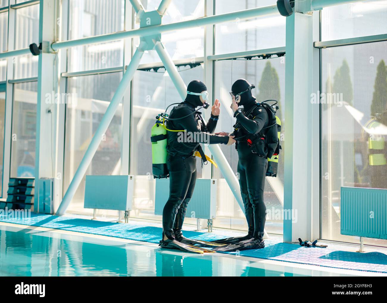 Male diver and divemaster in scuba gear, dive lesson in diving school ...