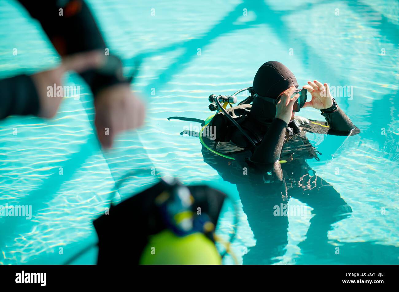 Male diver and divemaster in scuba gear mark the dive time, diving ...