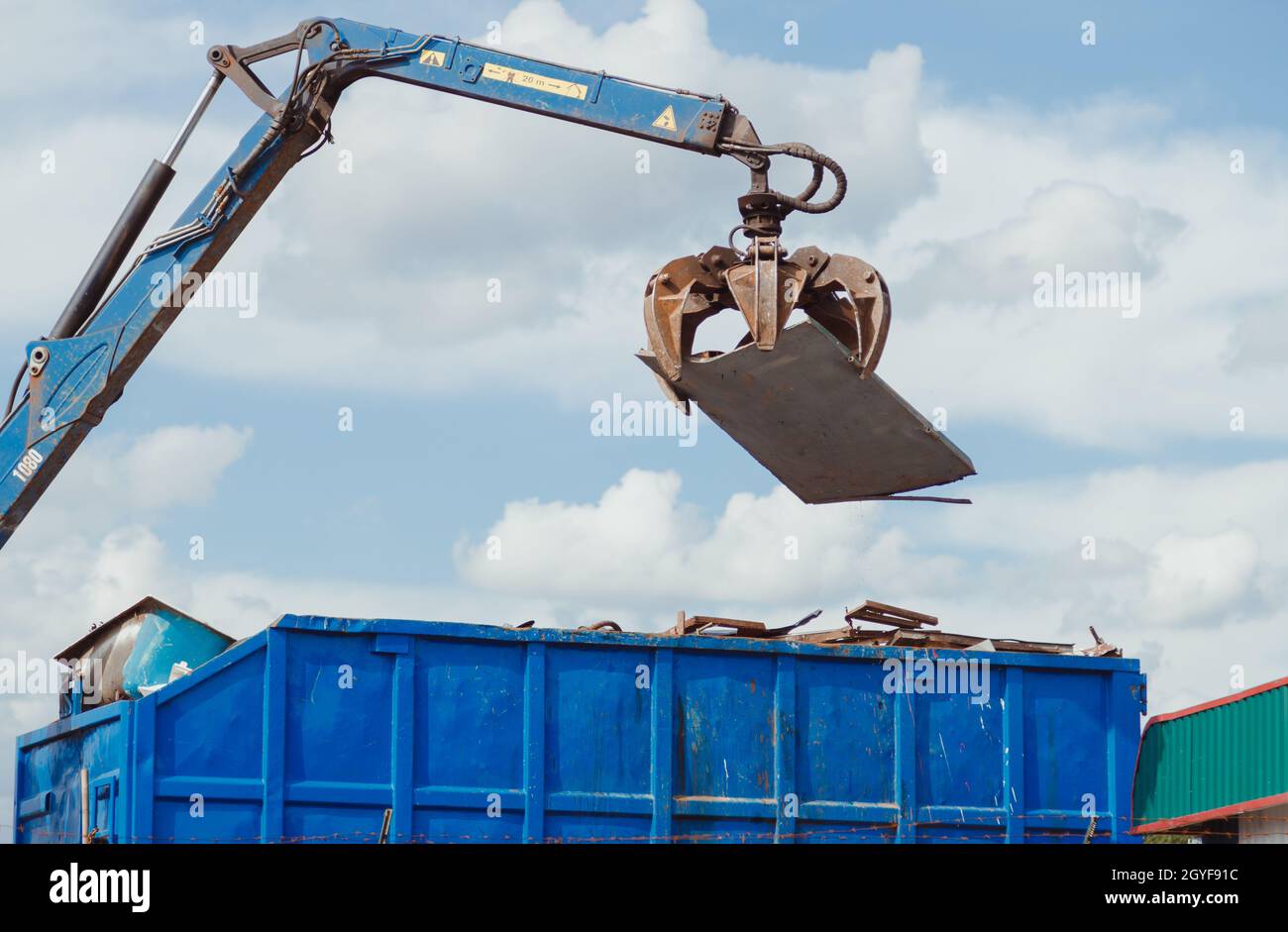 Crane-loading scrap grabber old metal at industrial metal recycling ...