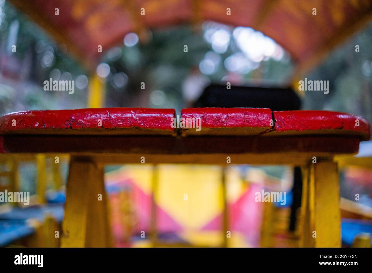 Rustic red and yellow wooden table with blurry background Stock Photo ...