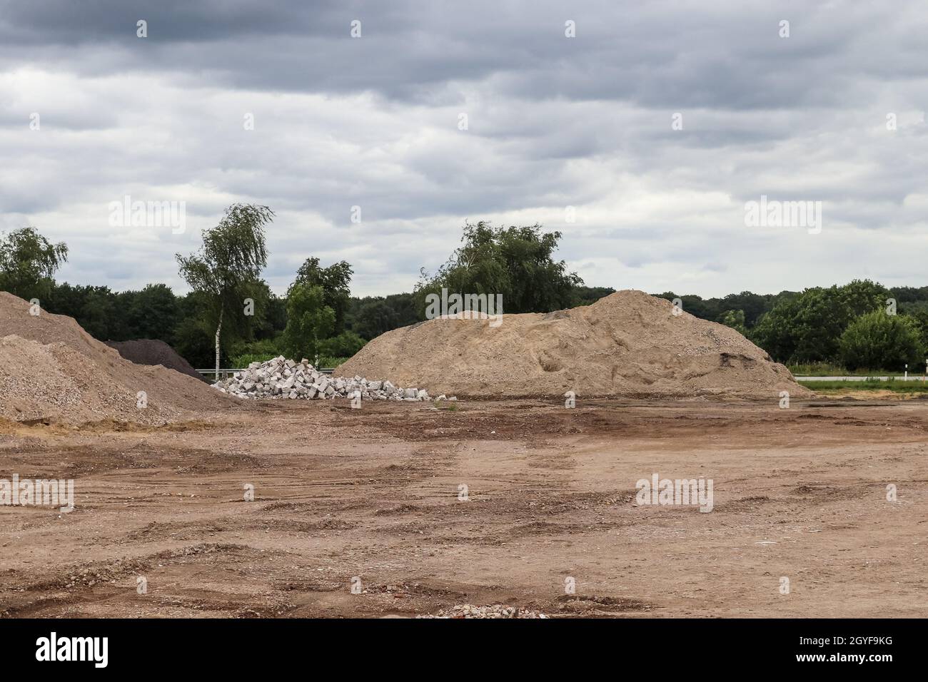 View into a gravel pit with piles of sand and tire tracks Stock Photo ...