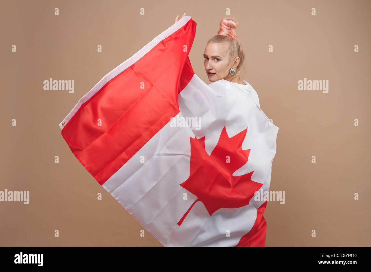 Beautiful asian woman, a sports fan, standing in front of a Canadian ...