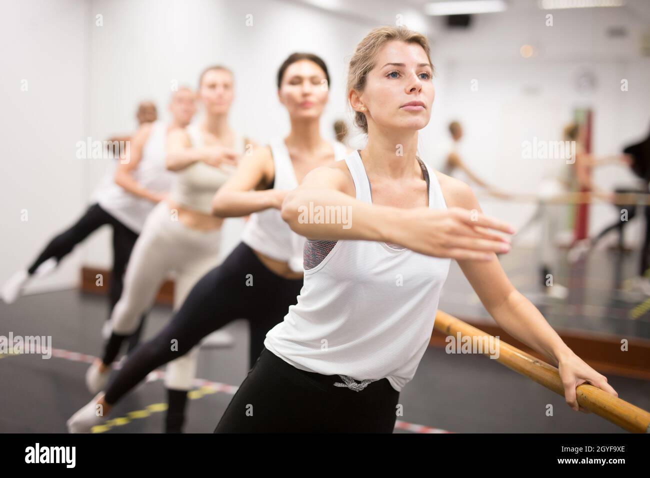 Ballet dancers practicing at barre in dance class Stock Photo - Alamy