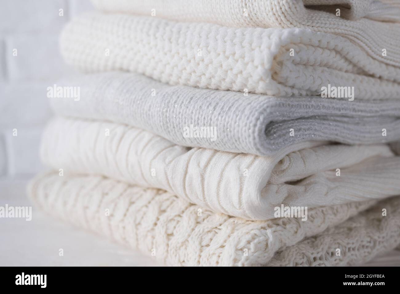 Warm, cozy clothes in light colors with different knitted patterns ...