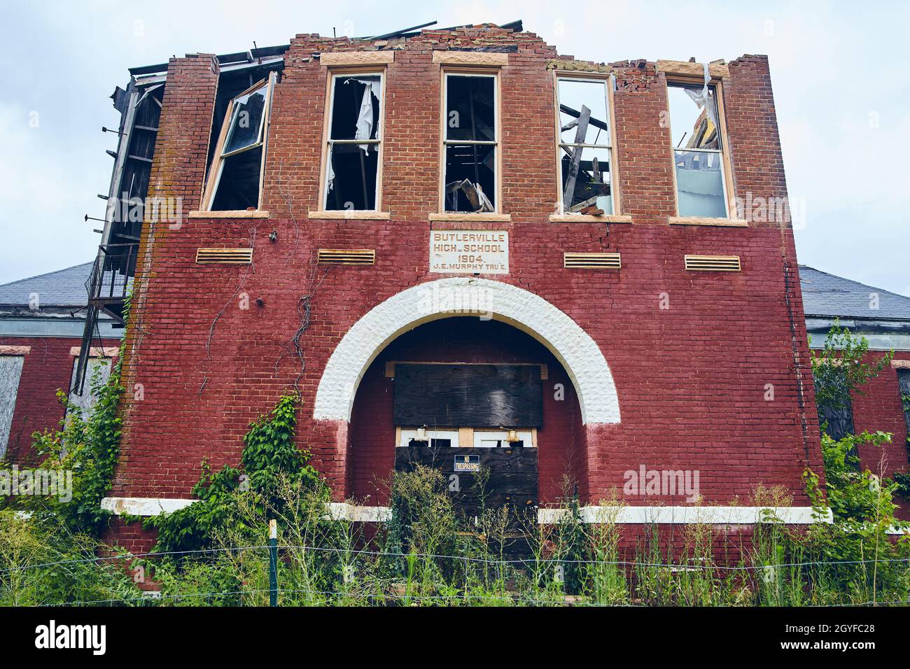 Small abandoned high school of red brick with broken windows and no ...