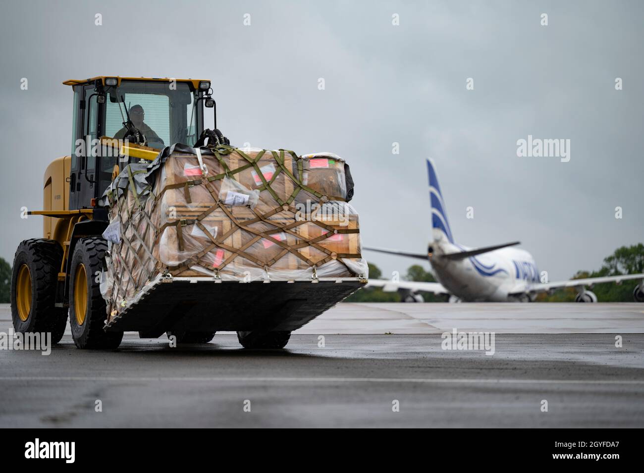 An Airman assigned to the 9th Expeditionary Bomb Squadron transports a ...