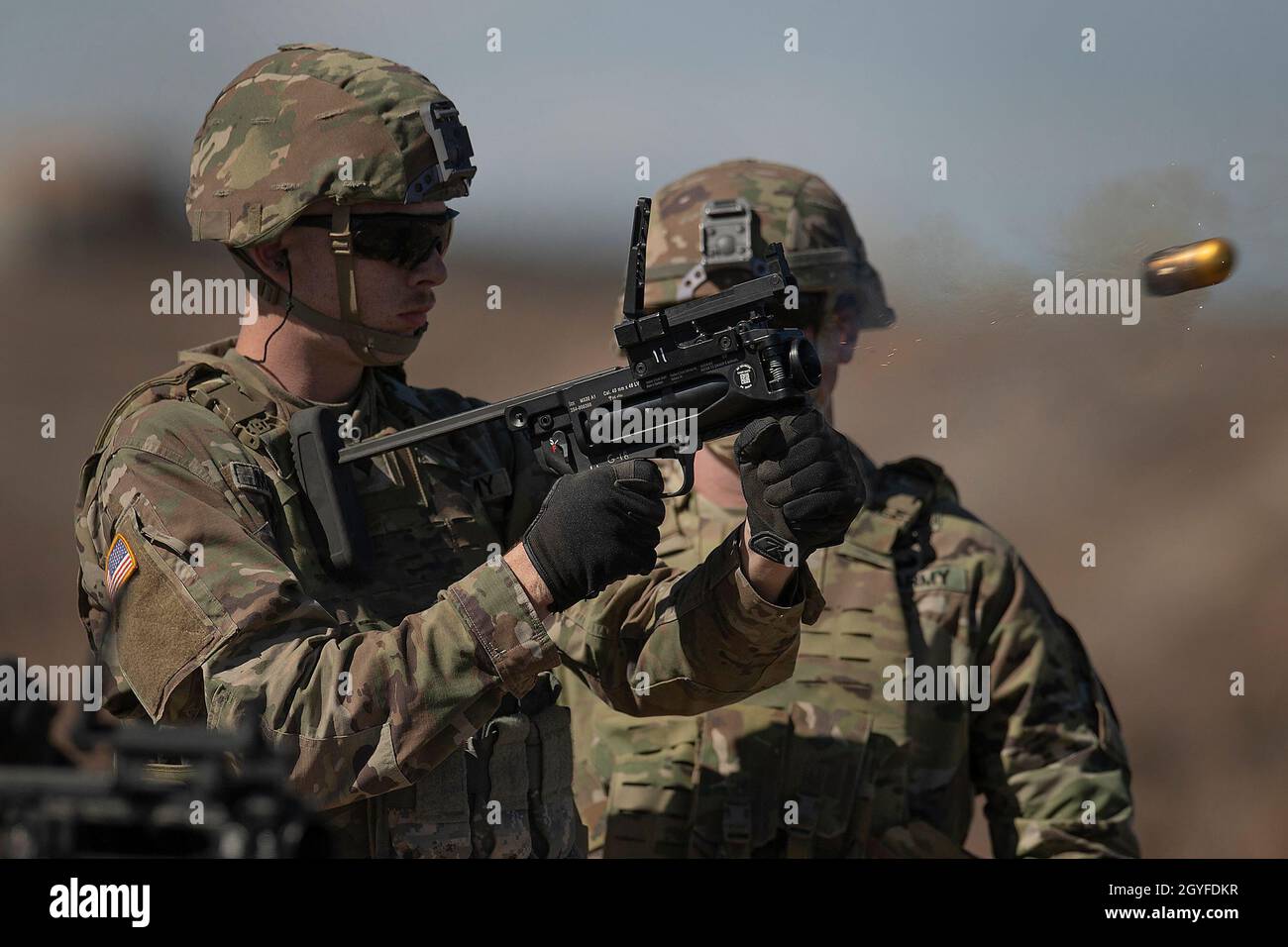 Idaho Army National Guard Spc. Garrett Malone fires a grenade from the ...