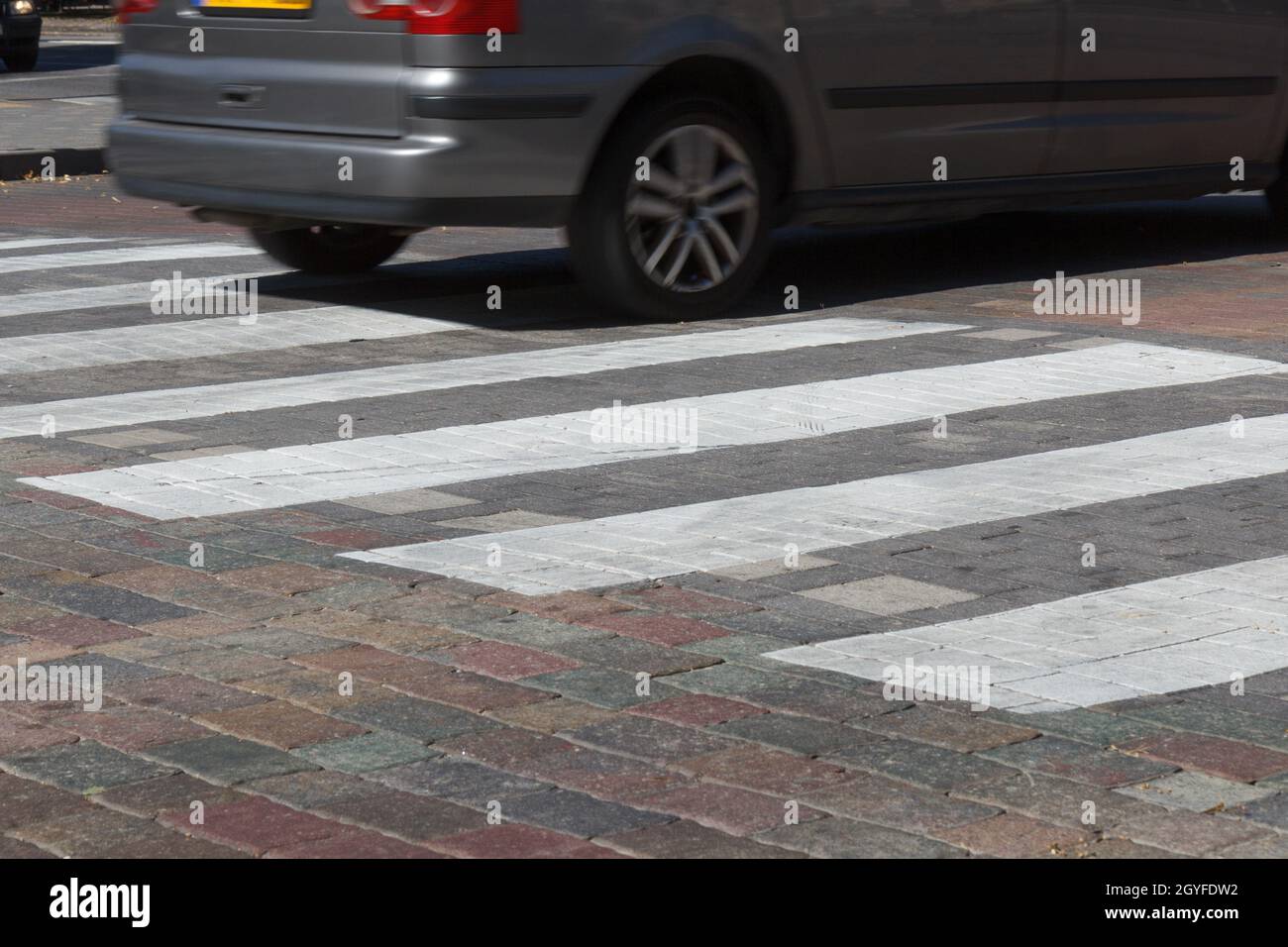 An empty pedestrian crossing and a car on it Stock Photo - Alamy