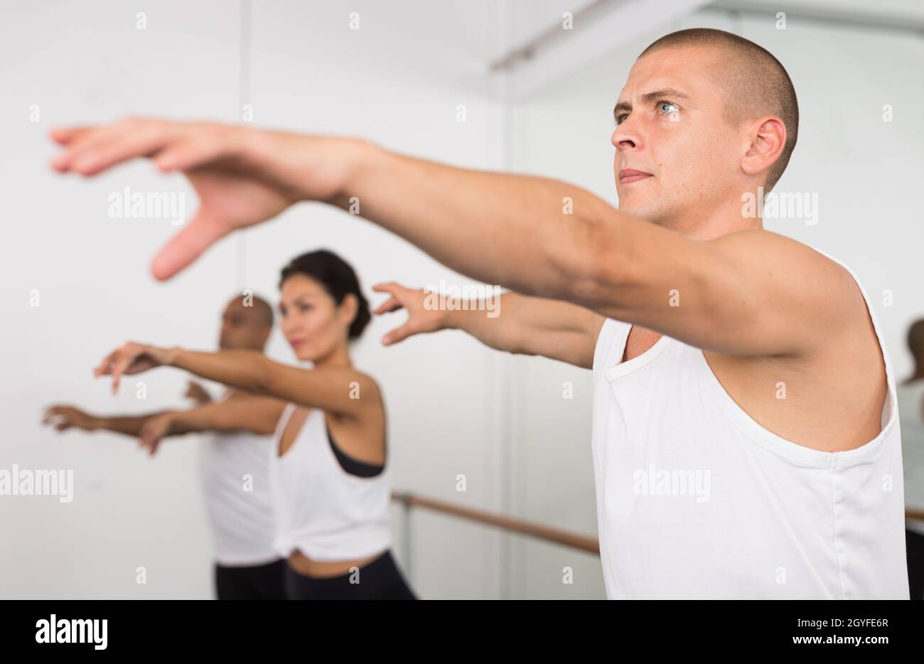 Man practicing ballet elements in class Stock Photo - Alamy