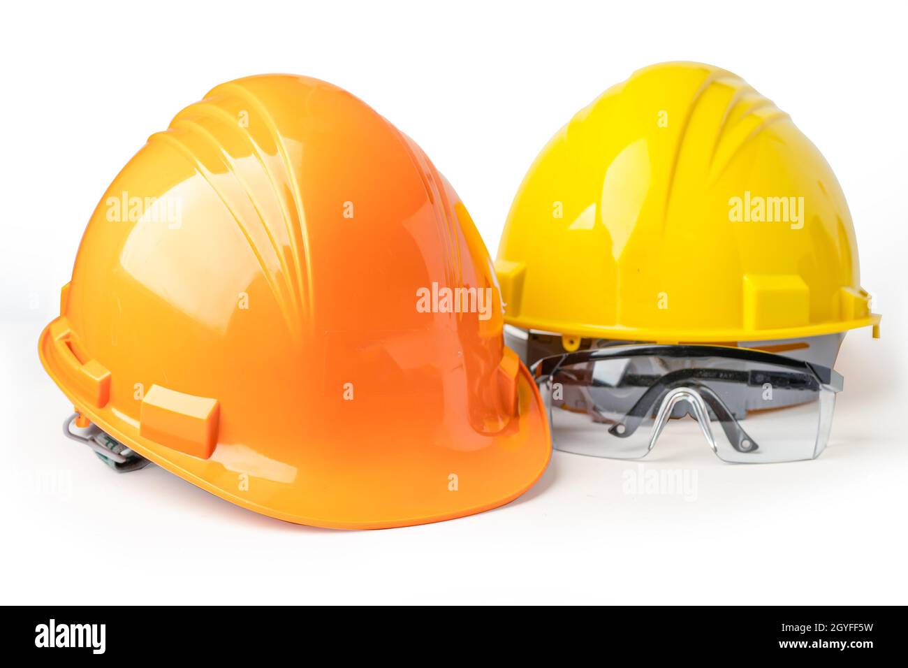 Yellow and orange construction helmet, safety glasses and magnifying ...