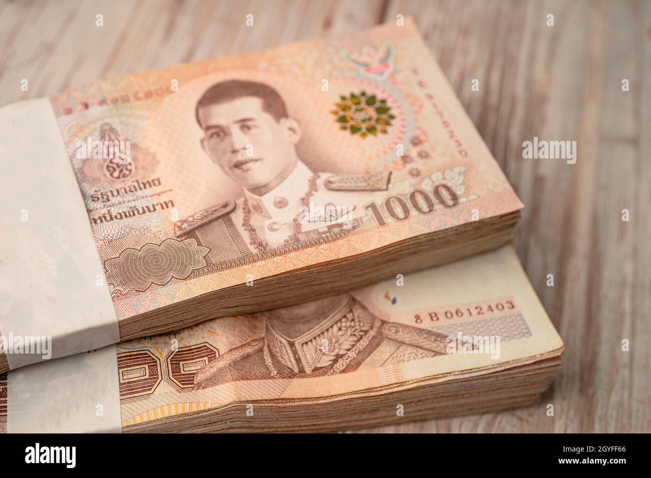 Stack of Thai baht banknotes on wooden background, business saving ...
