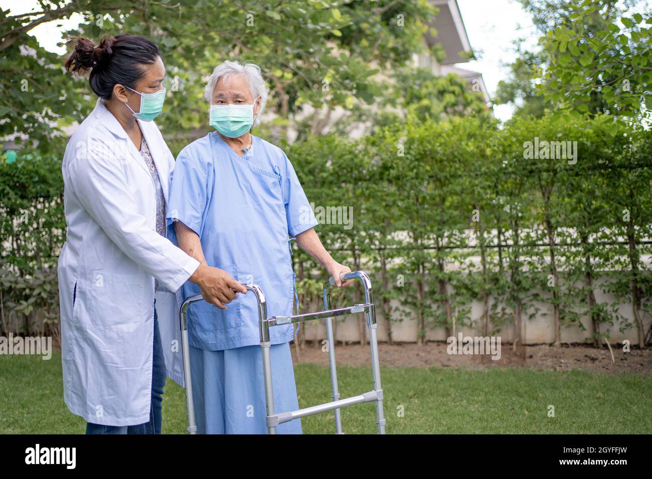 Help and care Asian senior or elderly old lady woman use walker with ...