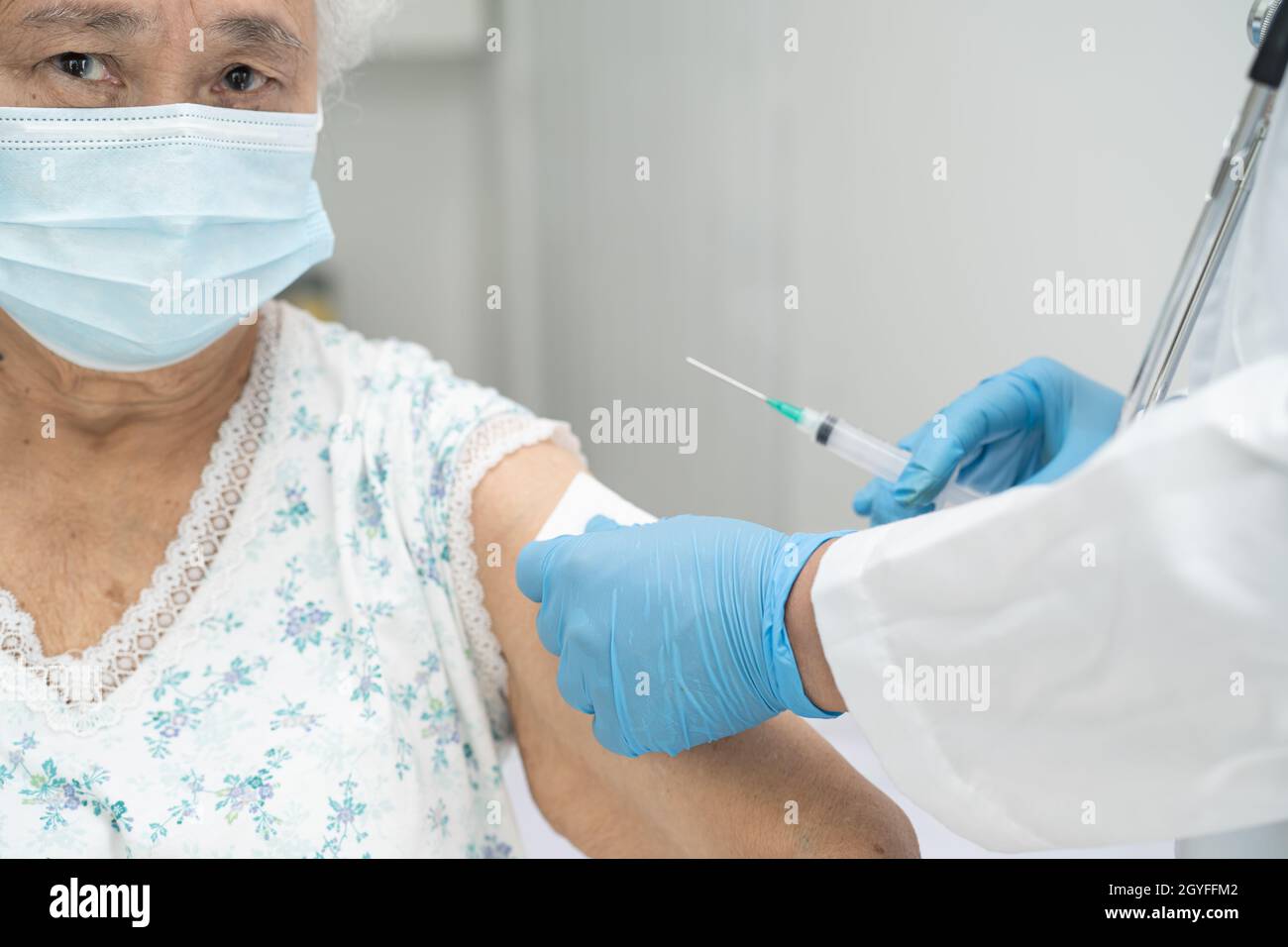Elderly Asian senior woman wearing face mask getting covid-19 or ...
