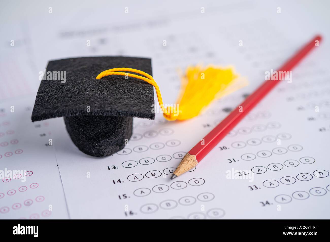 Graduation gap hat and pencil on answer sheet background, Education ...