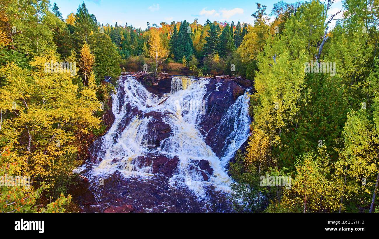 Trip Aerial of fall forest surrounding the Eagle River Falls steep ...