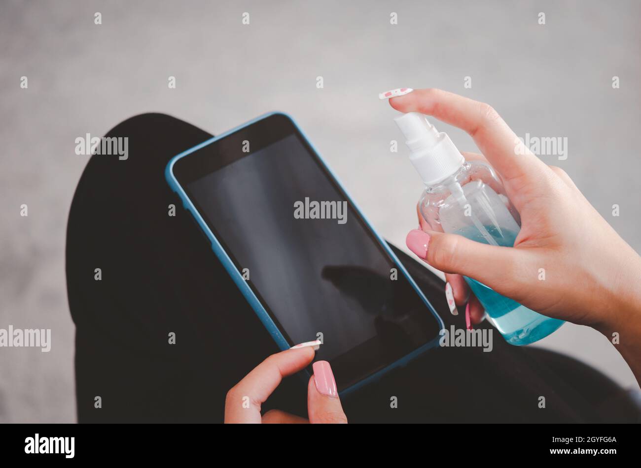 Spray to disinfect mobile phone with alcohol. concept of health care to ...