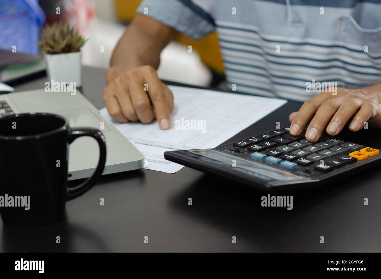 Business Man using calculator at a desk. Business finance, tax, and ...