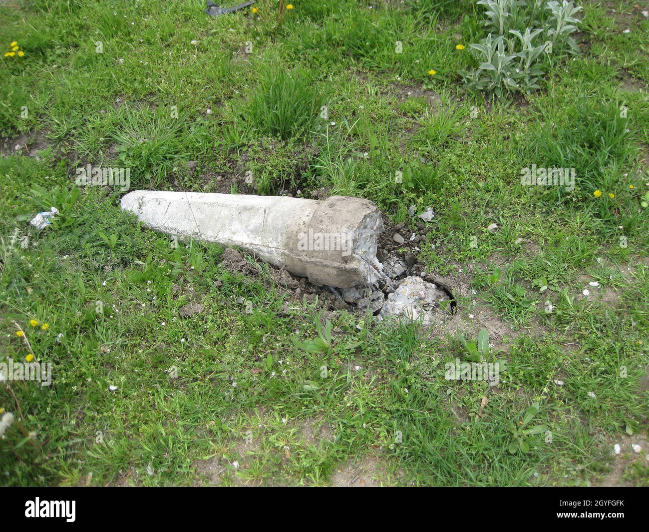 Broken concrete column. Destroyed a concrete fence on the grass Stock ...