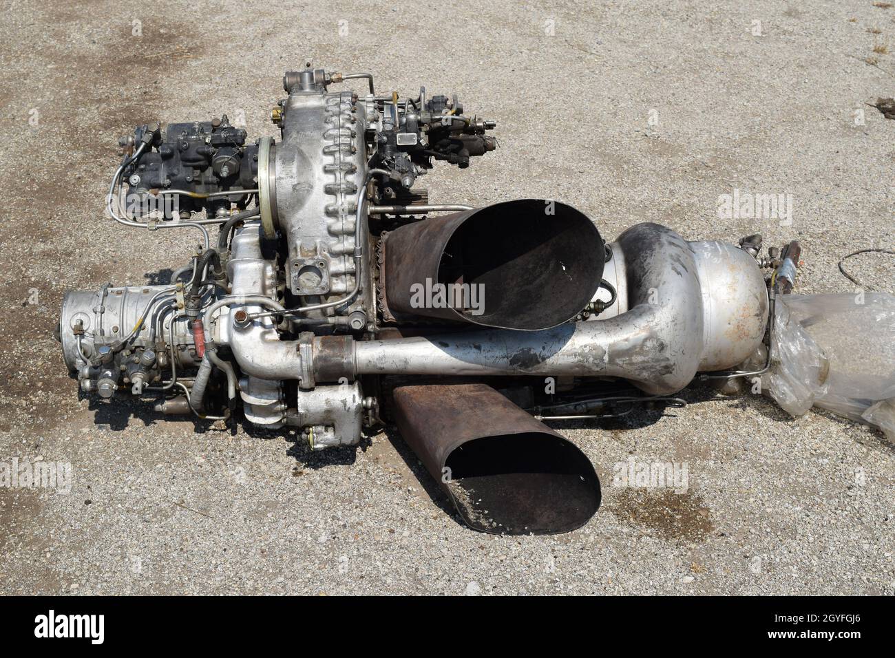 The helicopter engine which is pulled out outside. Spare parts and ...