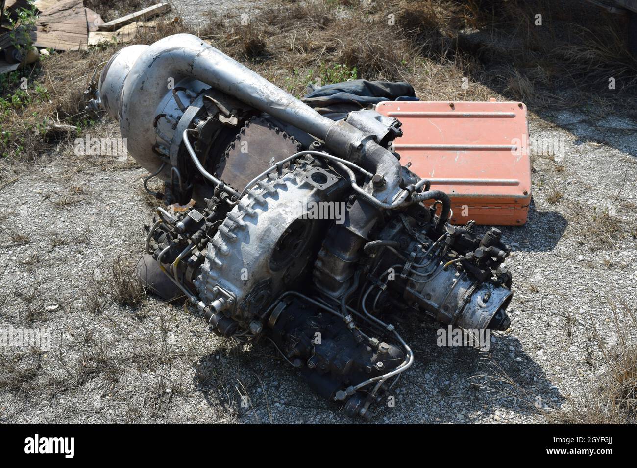 The helicopter engine which is pulled out outside. Spare parts and ...