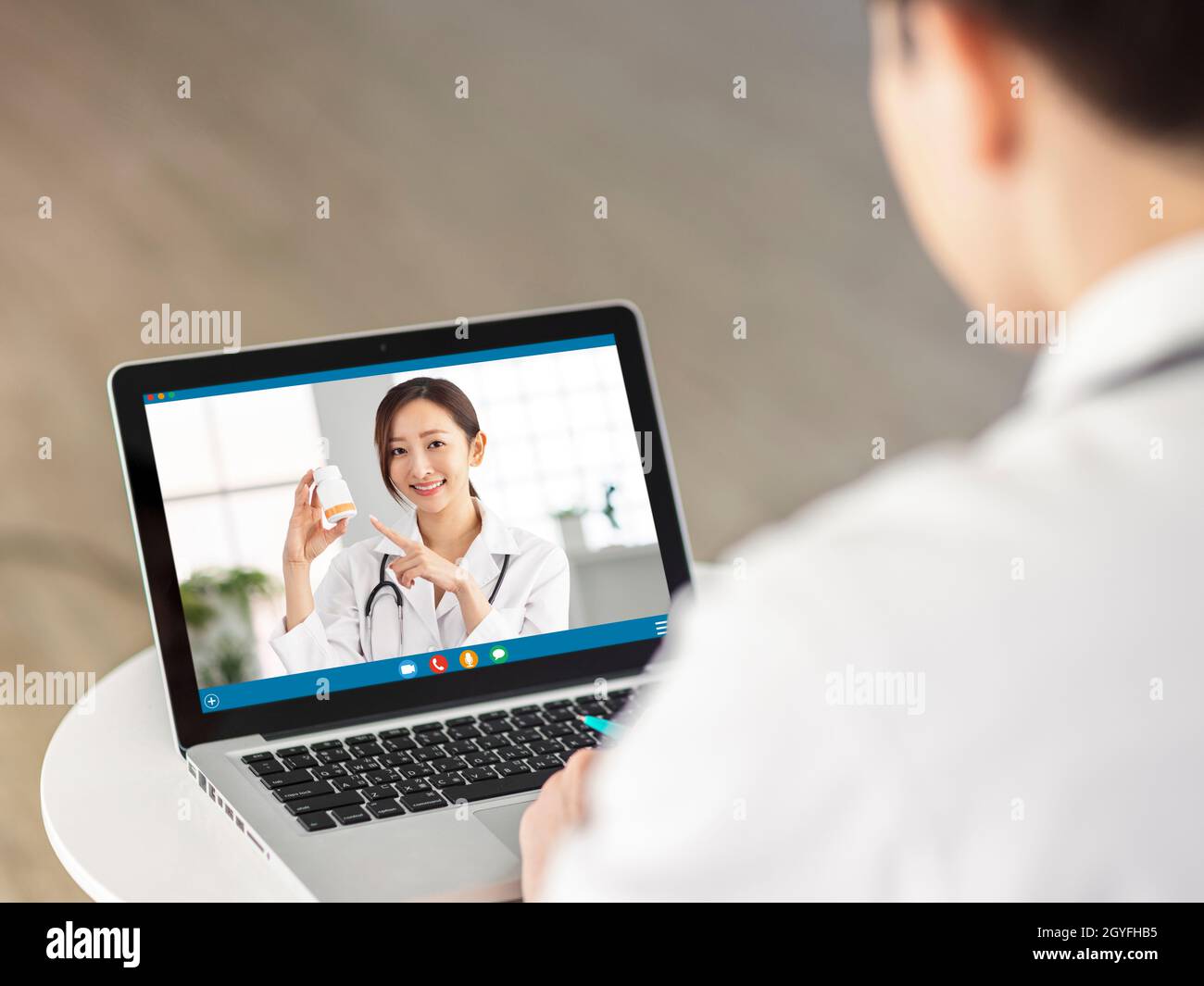 Back view of doctor making video call with his colleague.Smiling doctor ...