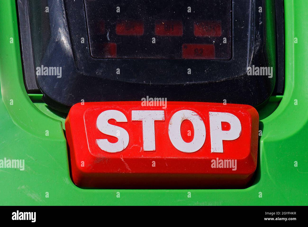 Large red switch stop sign on modern machine Stock Photo - Alamy