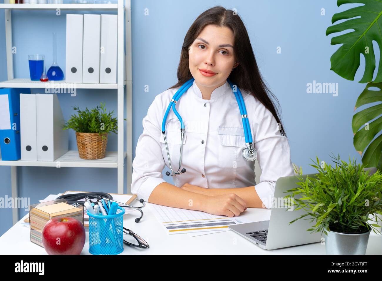 Woman doctor portrait at her office desk, office interior Stock Photo ...