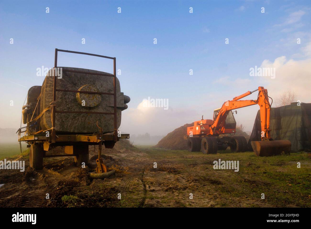 Excavator and other heavy equipment on a farm near the Dutch village ...
