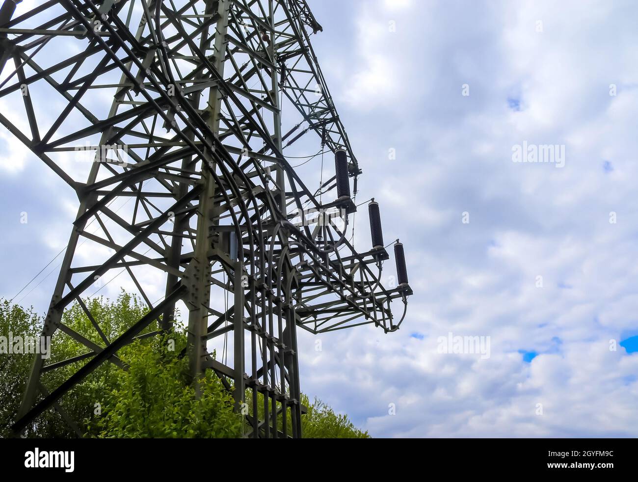 Close up view on a big power pylon transporting electricity in a ...
