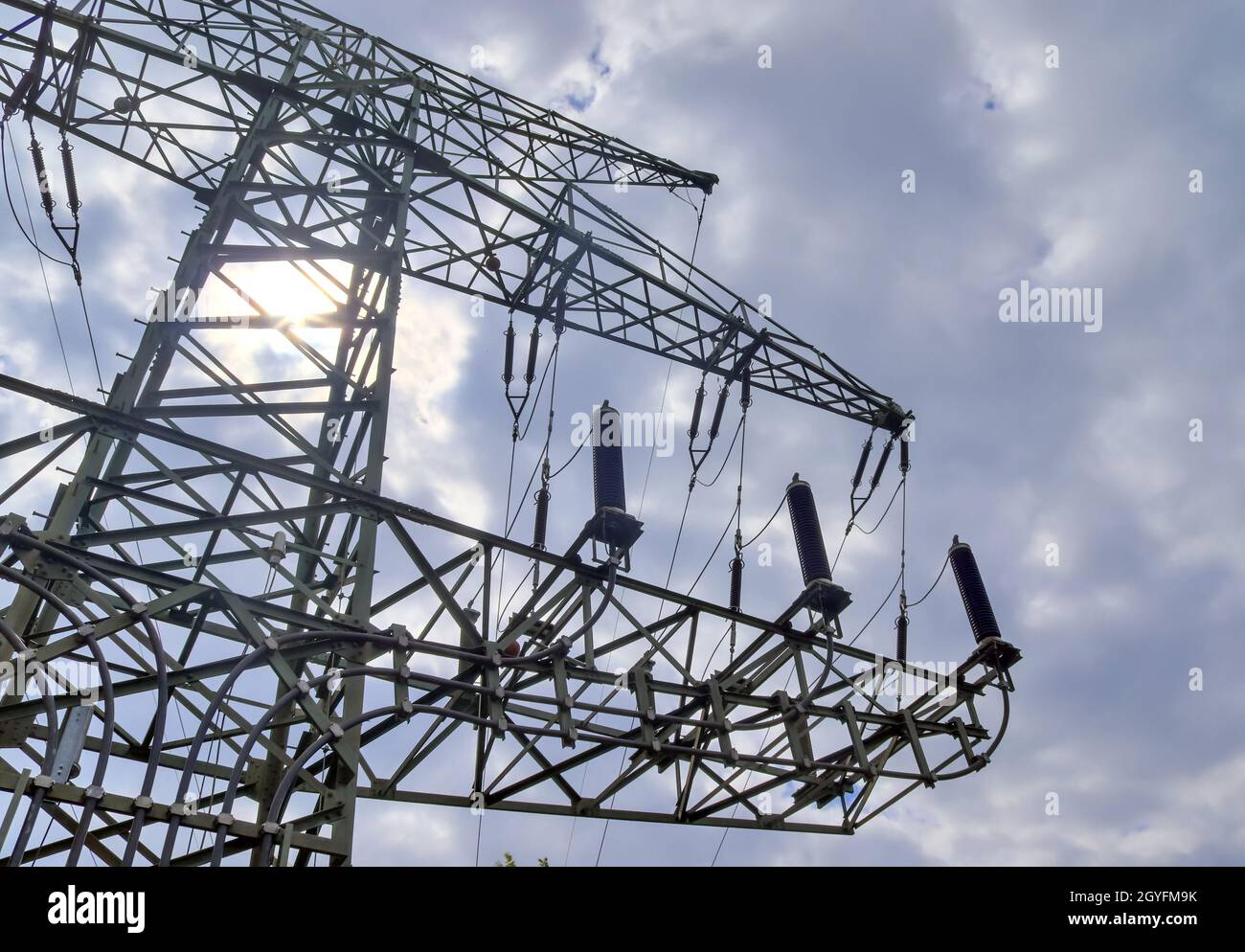 Close up view on a big power pylon transporting electricity in a ...