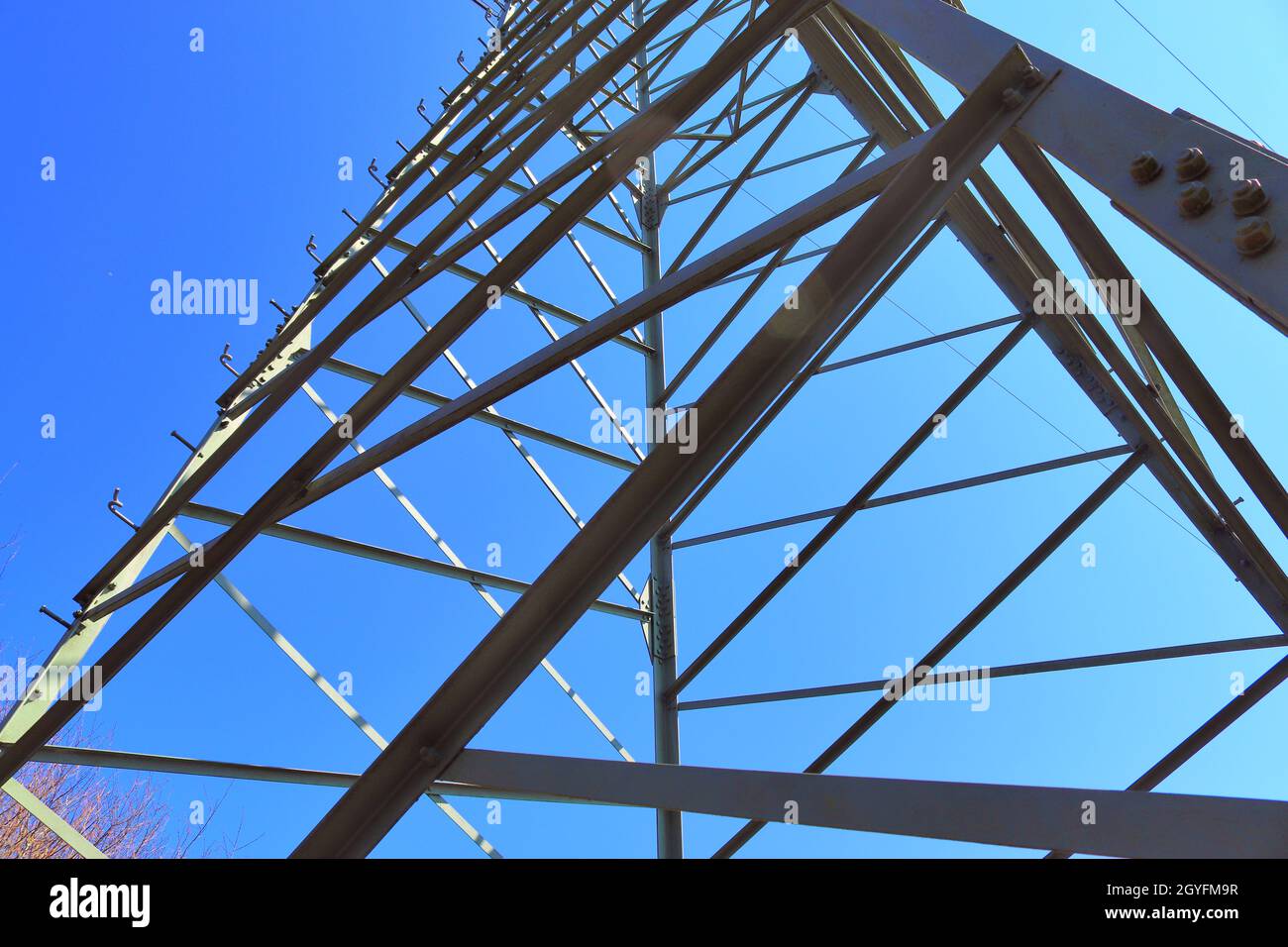 Close up view on a big power pylon transporting electricity in a ...