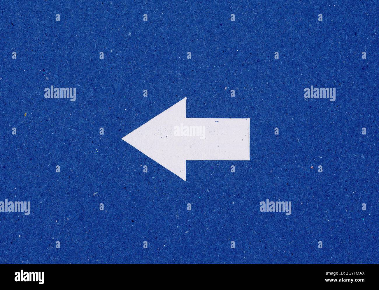 white left arrow sign on blue background Stock Photo - Alamy