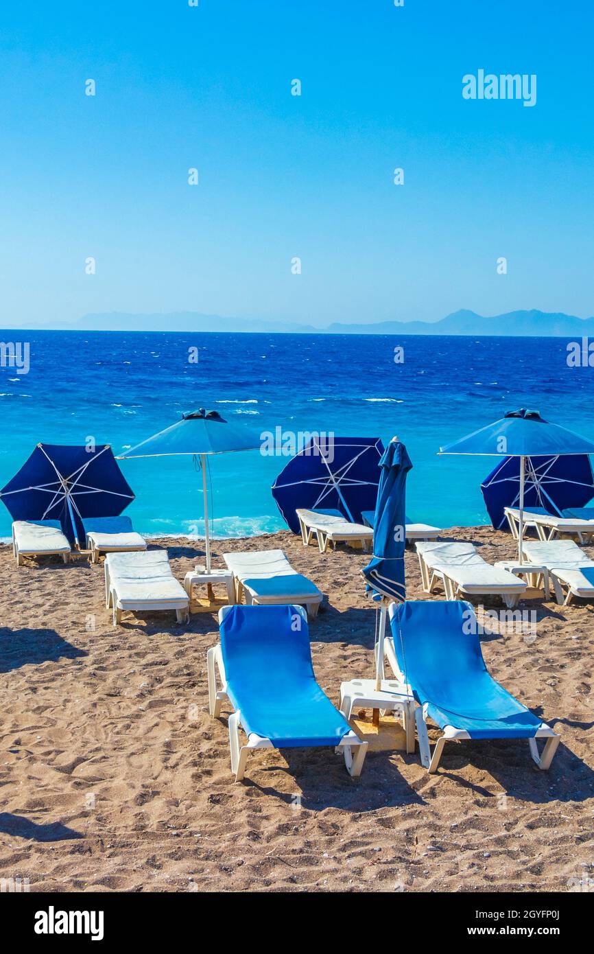 Relax on blue sun loungers at vacation in Rhodes Greece with beautiful ...