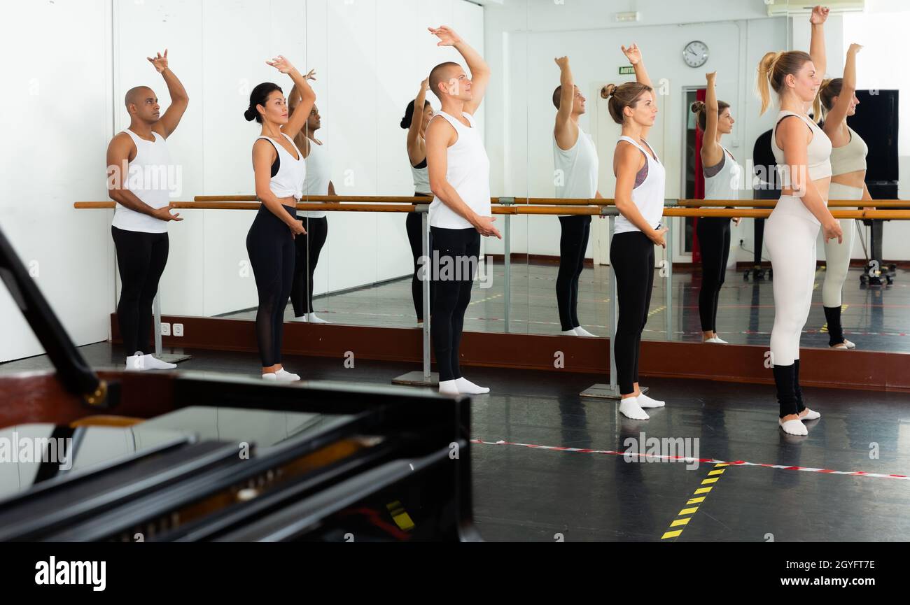 Dancers doing exercises on stretching ballet barre Stock Photo - Alamy
