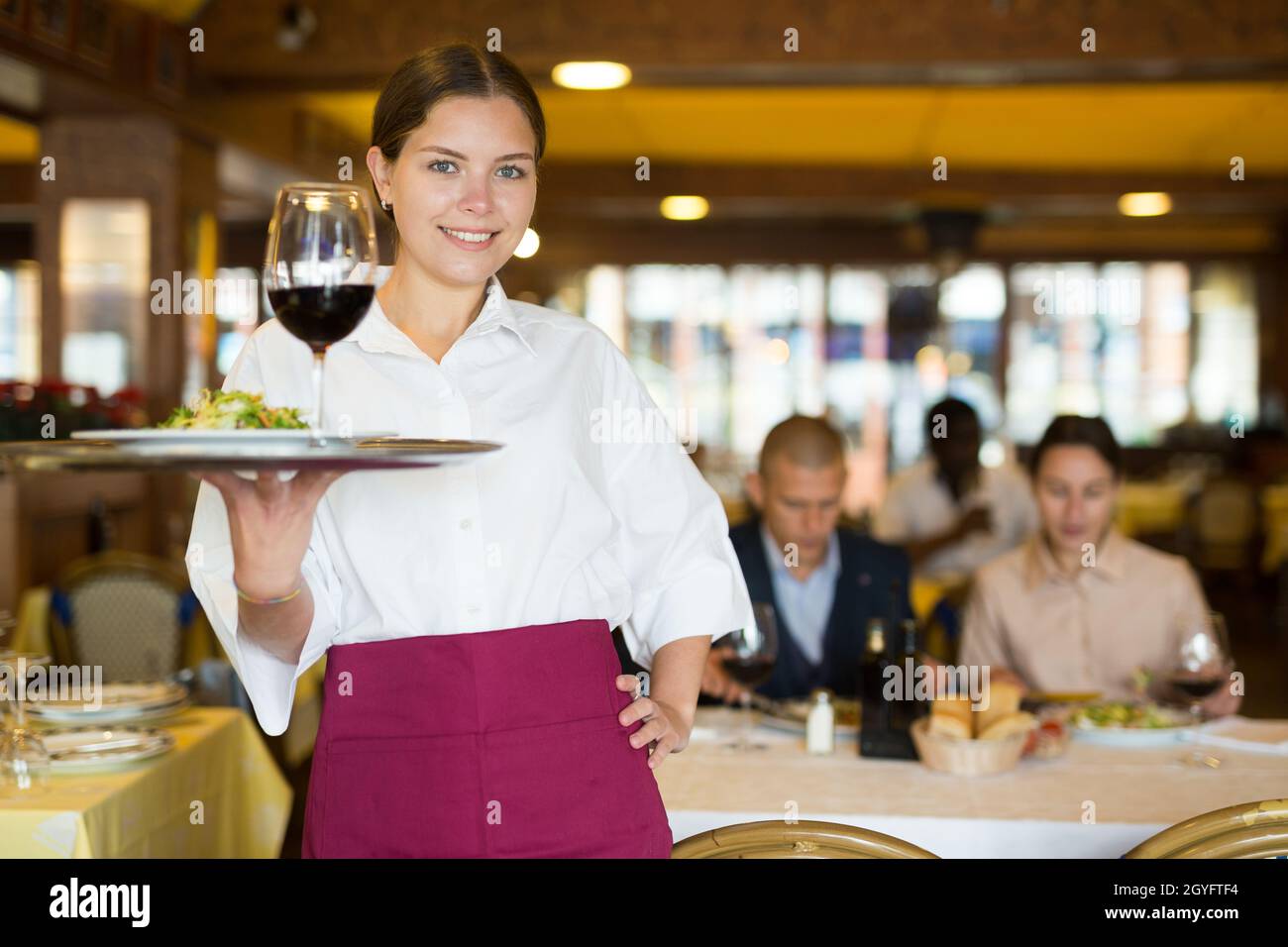 Professional attractive female waiter holding serving tray Stock Photo ...