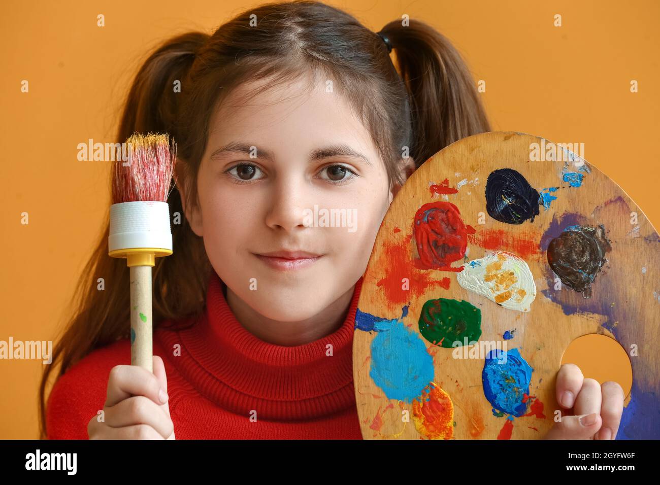 Cute little painter on color background Stock Photo - Alamy