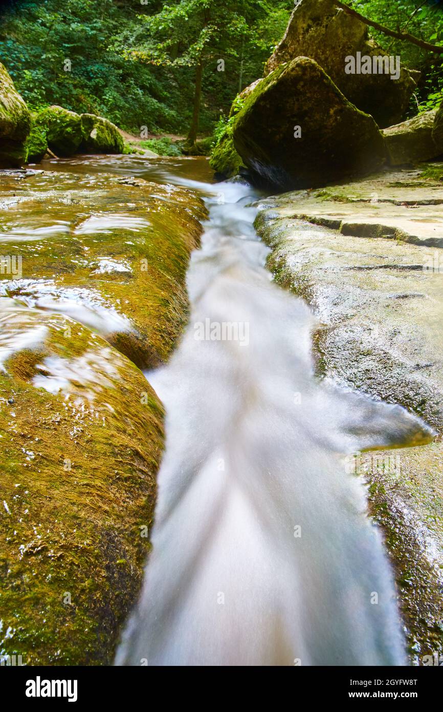 White water current of a stream that flows over rocks and passes ...