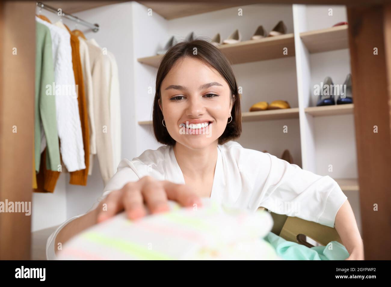 Woman arranging closet hi-res stock photography and images - Alamy