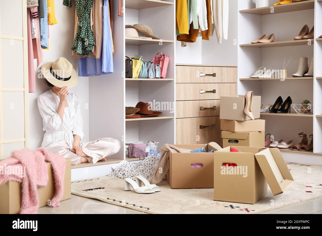 Woman arranging wardrobe hi-res stock photography and images - Alamy