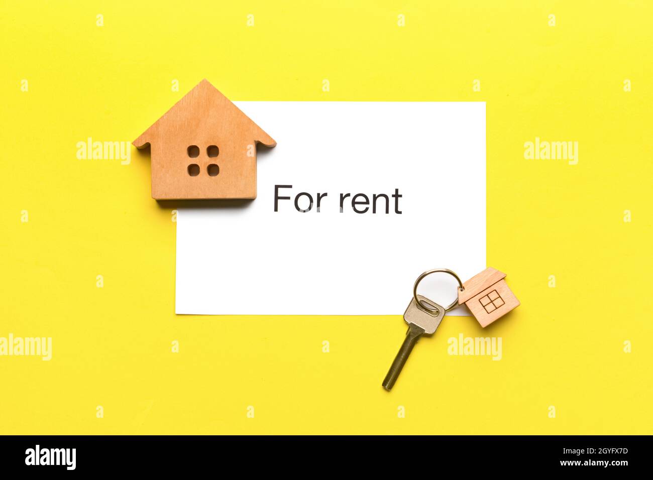 Wooden house with text FOR RENT and key on yellow background Stock ...