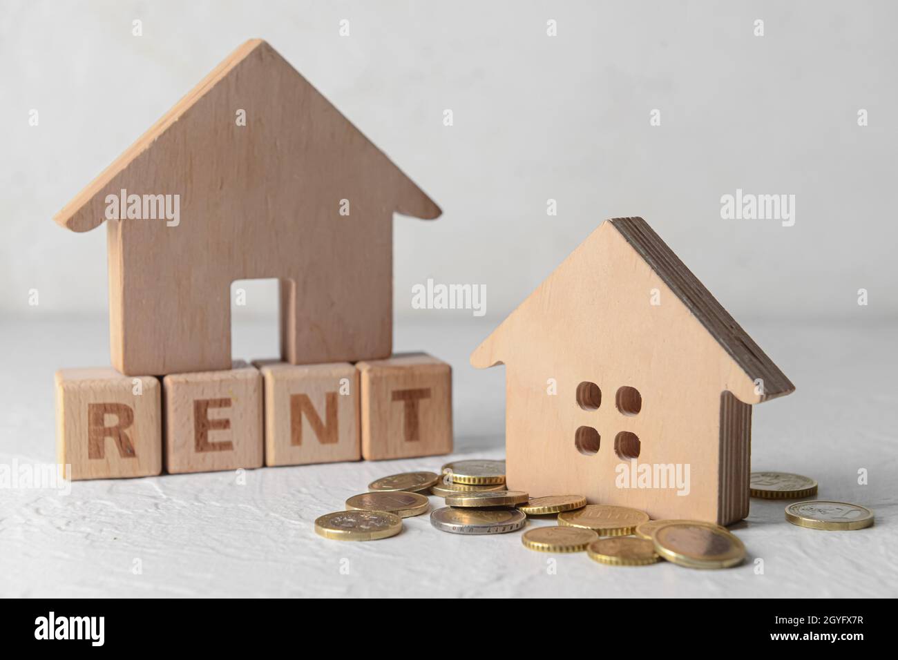Wooden houses with word RENT on white background Stock Photo - Alamy