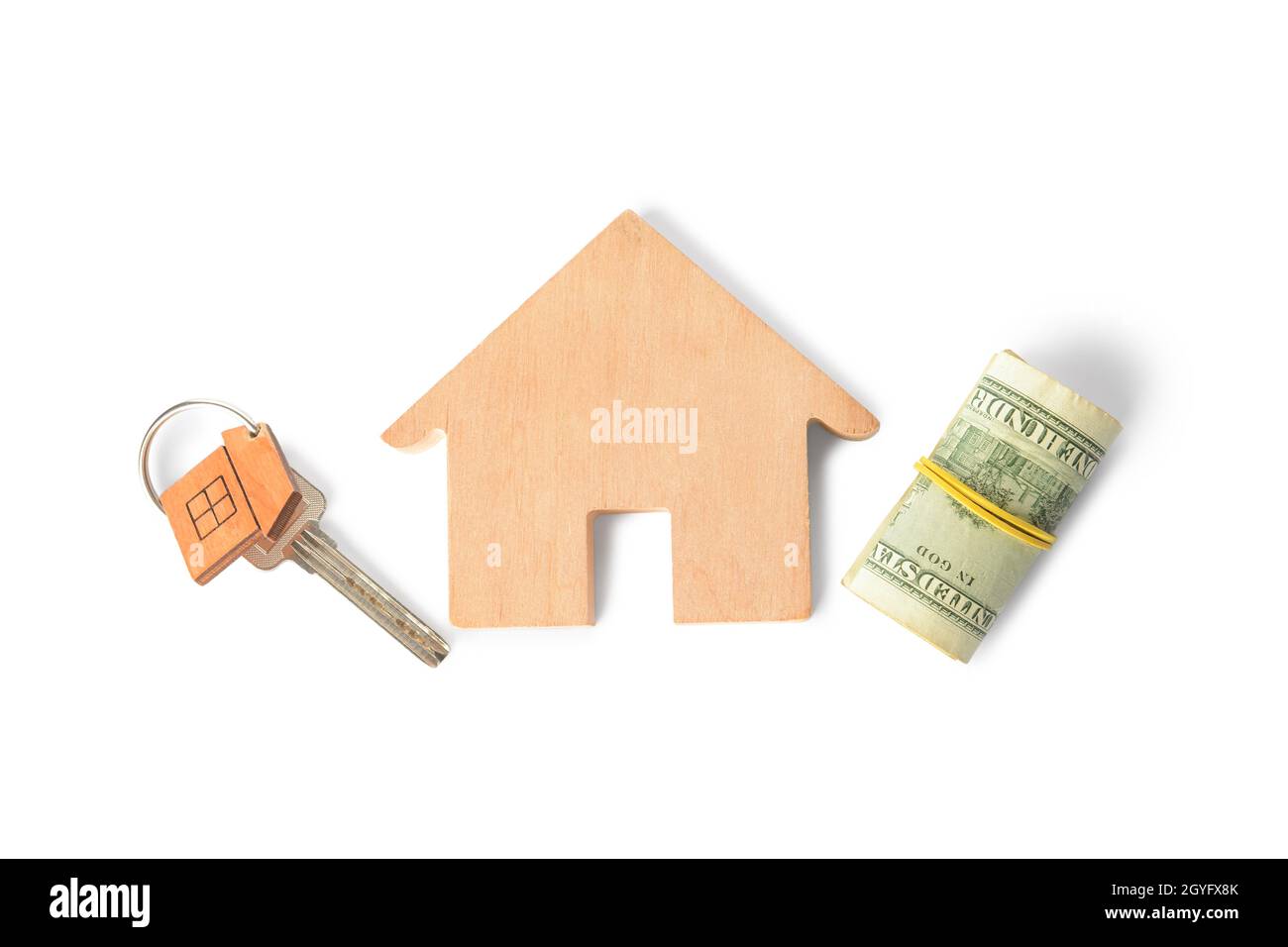 Wooden house with money and key on white background Stock Photo - Alamy