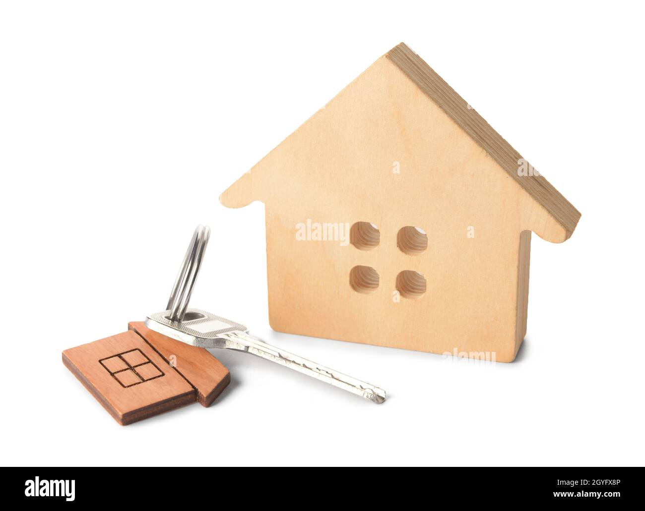 Wooden house and key on white background Stock Photo - Alamy