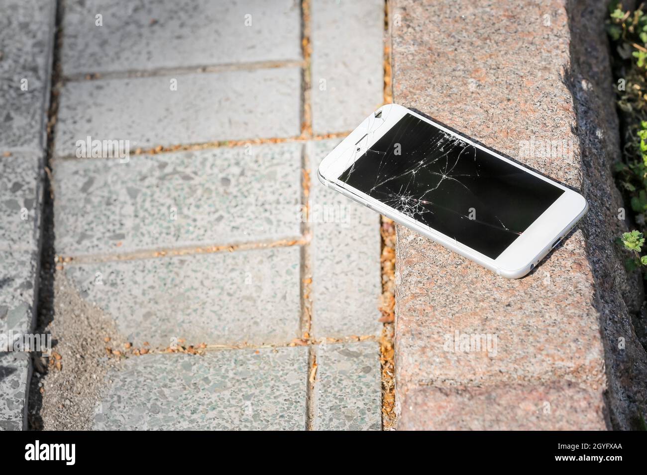 Damaged mobile phone on pavement outdoors, closeup Stock Photo - Alamy