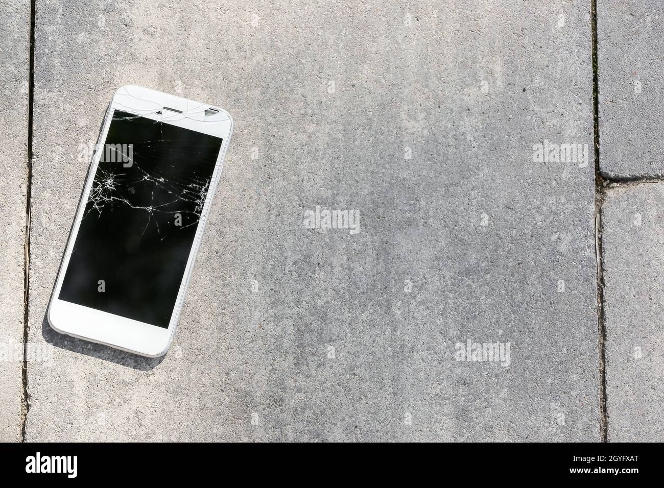 Damaged mobile phone on pavement outdoors Stock Photo - Alamy