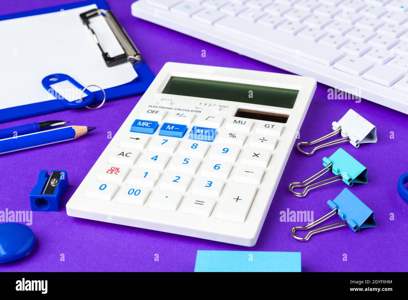 Composition of office lifestyle items on purple background, computer ...