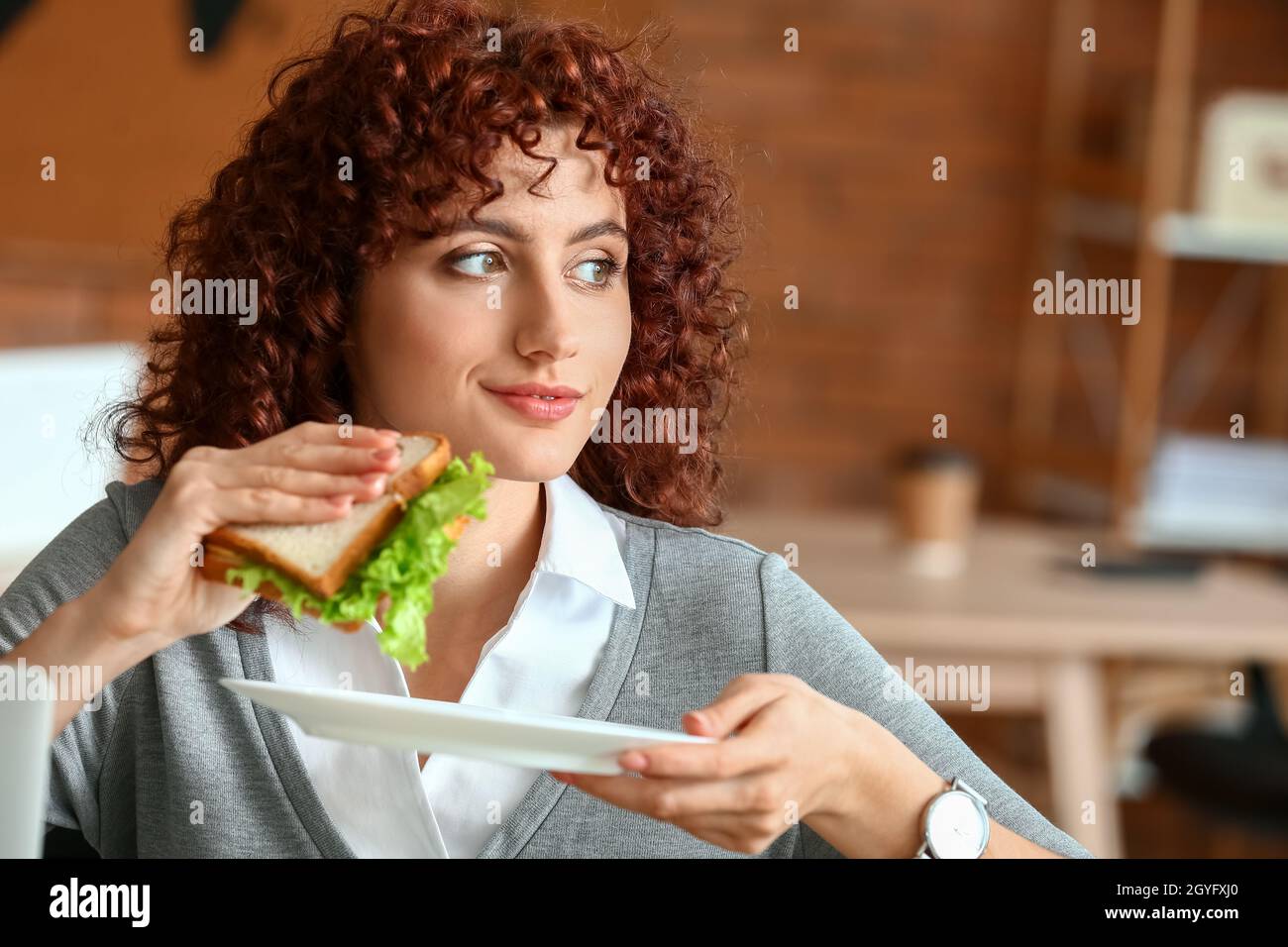 Woman eating bread triangle sandwich hi-res stock photography and ...