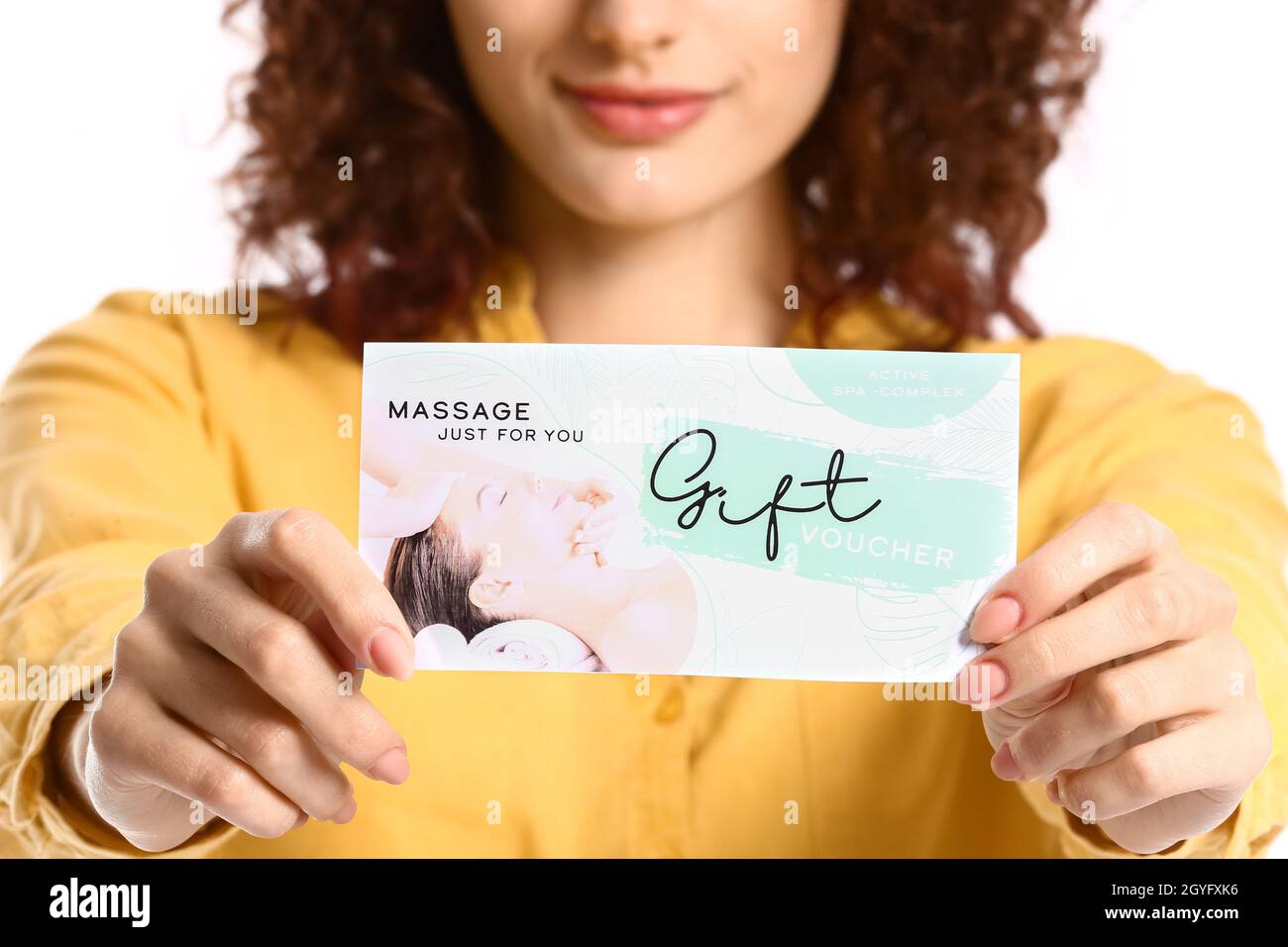 Pretty young woman with gift voucher on white background Stock Photo ...