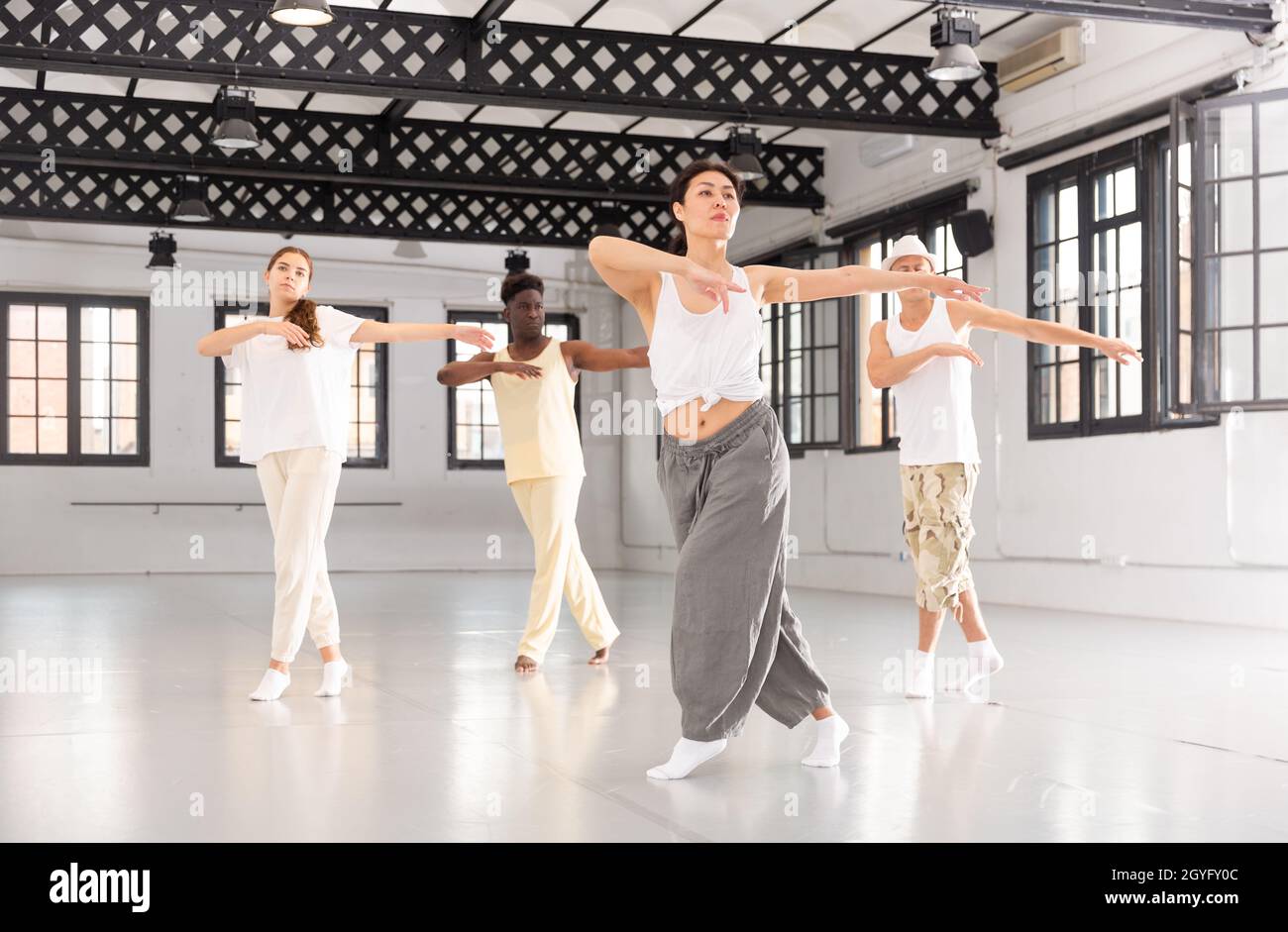 Four dancers exercising contemporary dance movements Stock Photo - Alamy